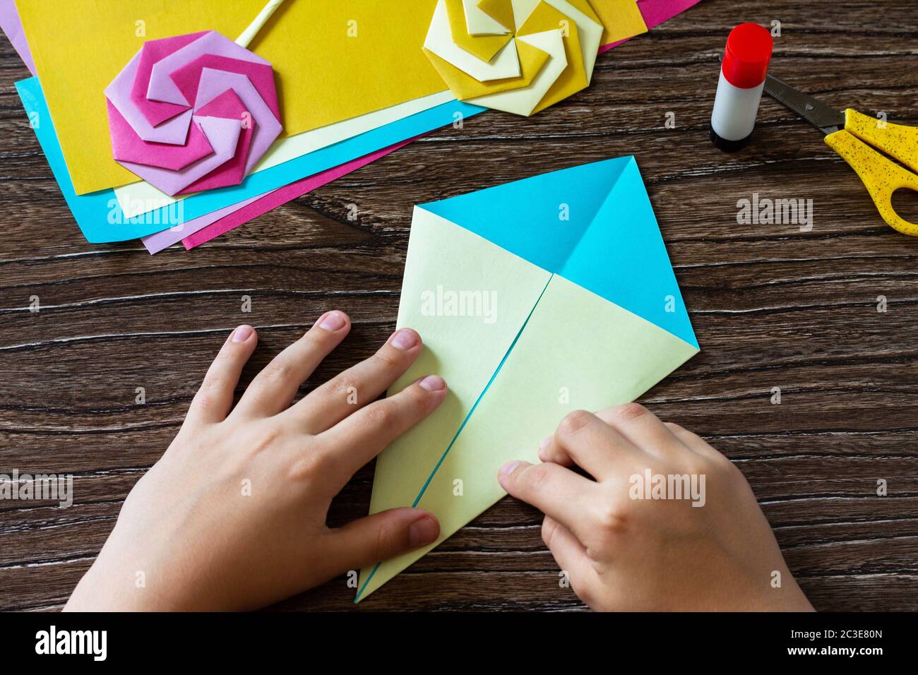 Instruction step 4. Funny toy Origami paper ice cream on a wooden table ...