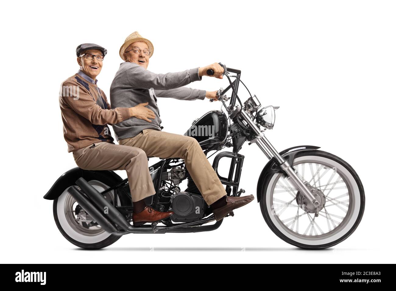 Two elderly men riding a chopper motorbile and looking at the camera ...