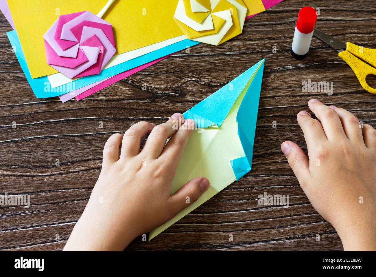 Instruction step 7. Funny toy Origami paper ice cream on a wooden table ...