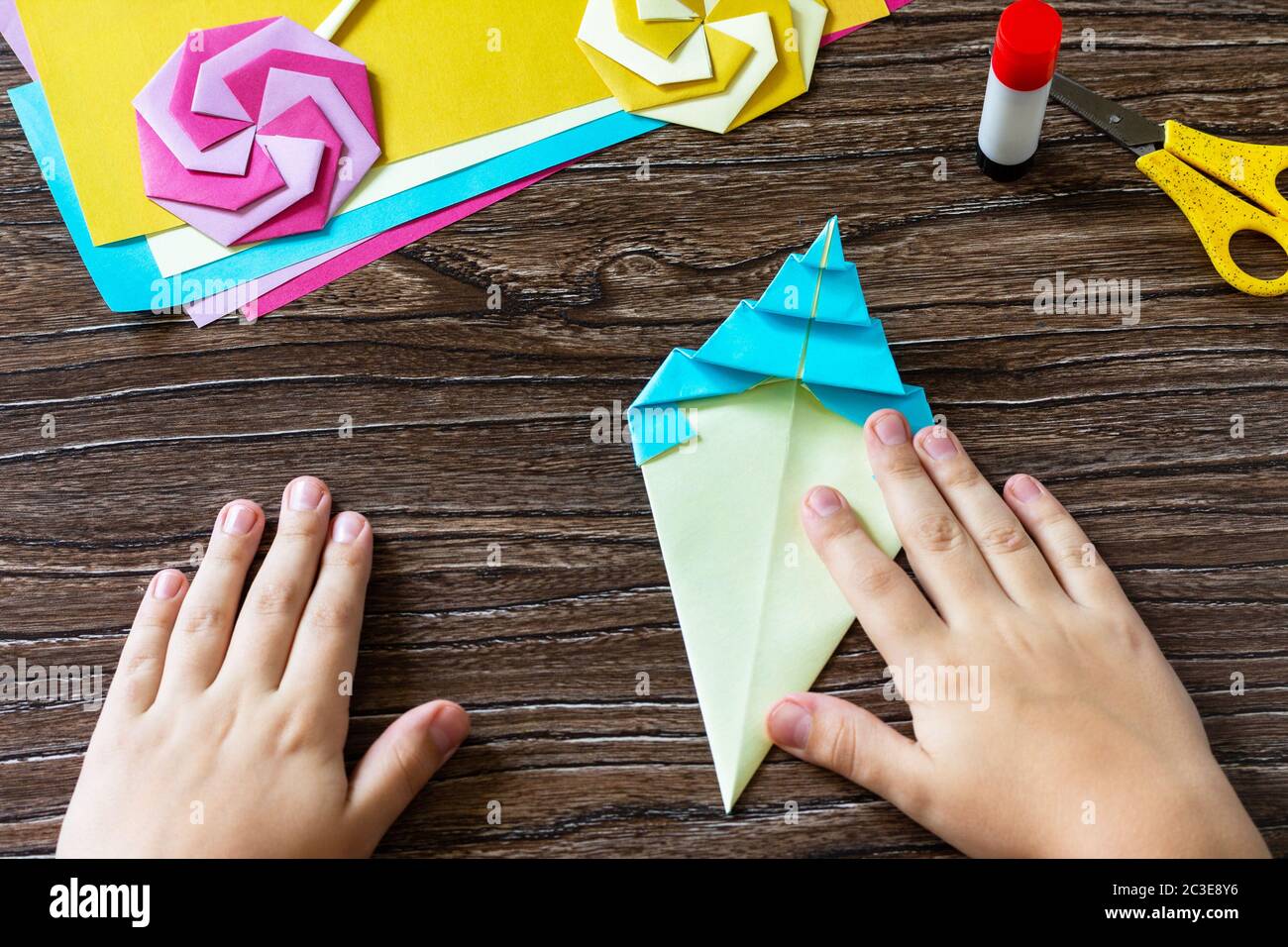 Instruction step 10. Funny toy Origami paper ice cream on a wooden ...