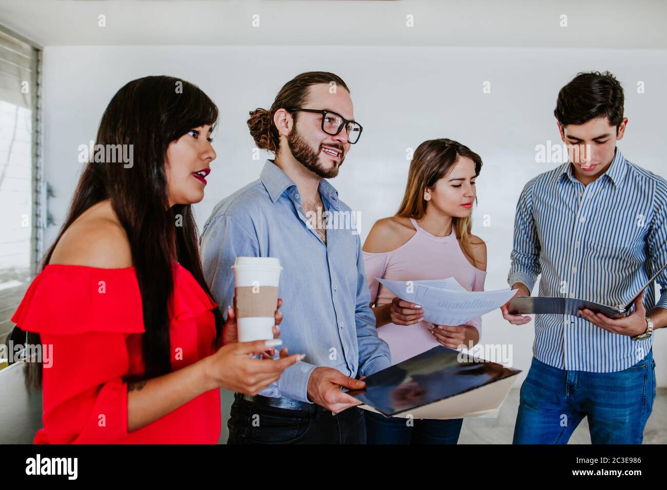 Group of young Latin people teamwork or mexican coworkers working in an ...
