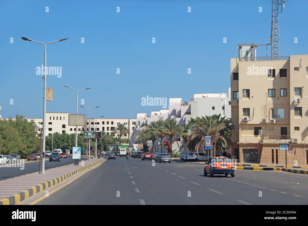 City panorama with street cars about buildings in Hurghada. Modern city ...
