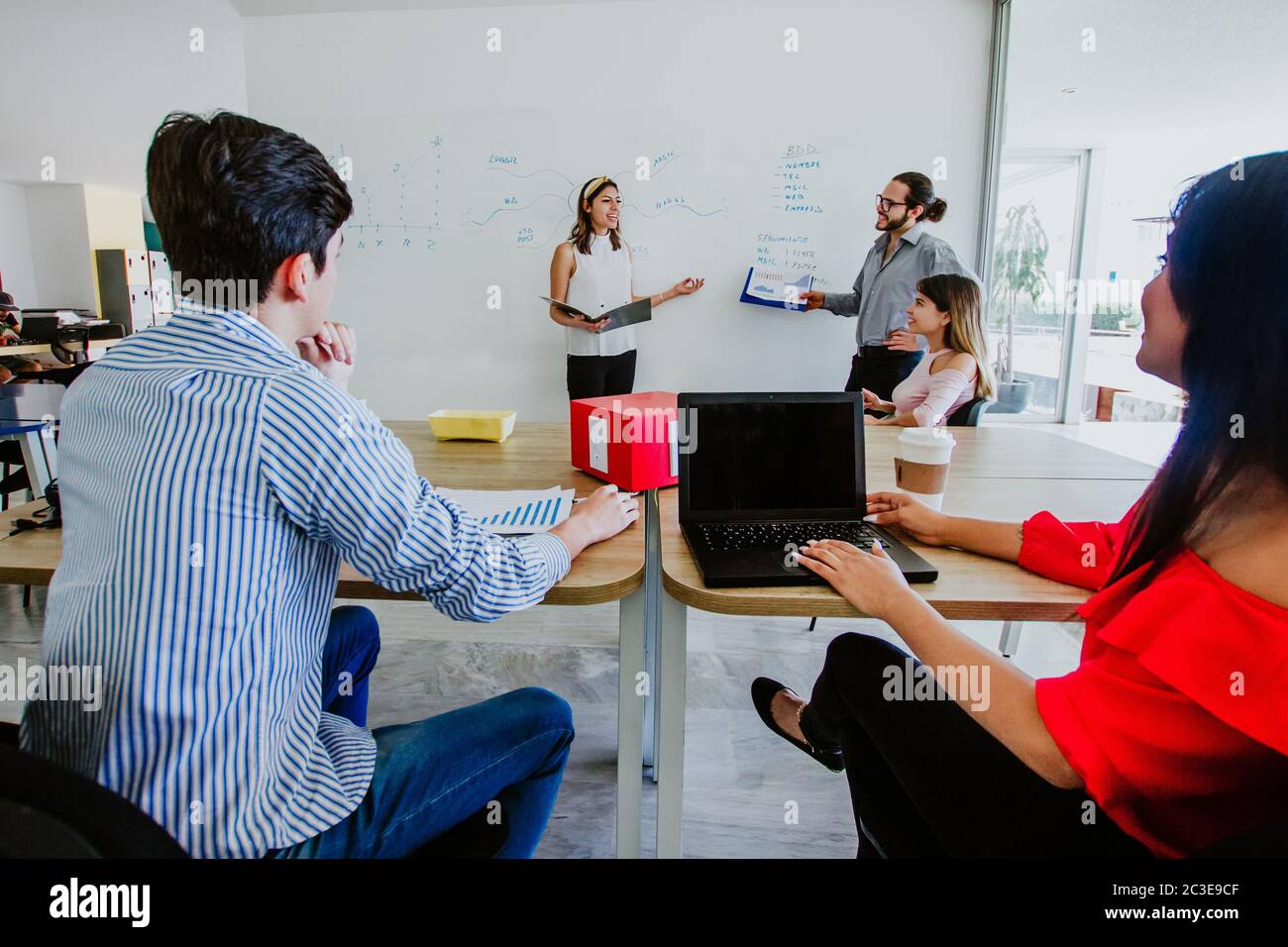 Group of young Latin people teamwork or mexican coworkers working in an ...
