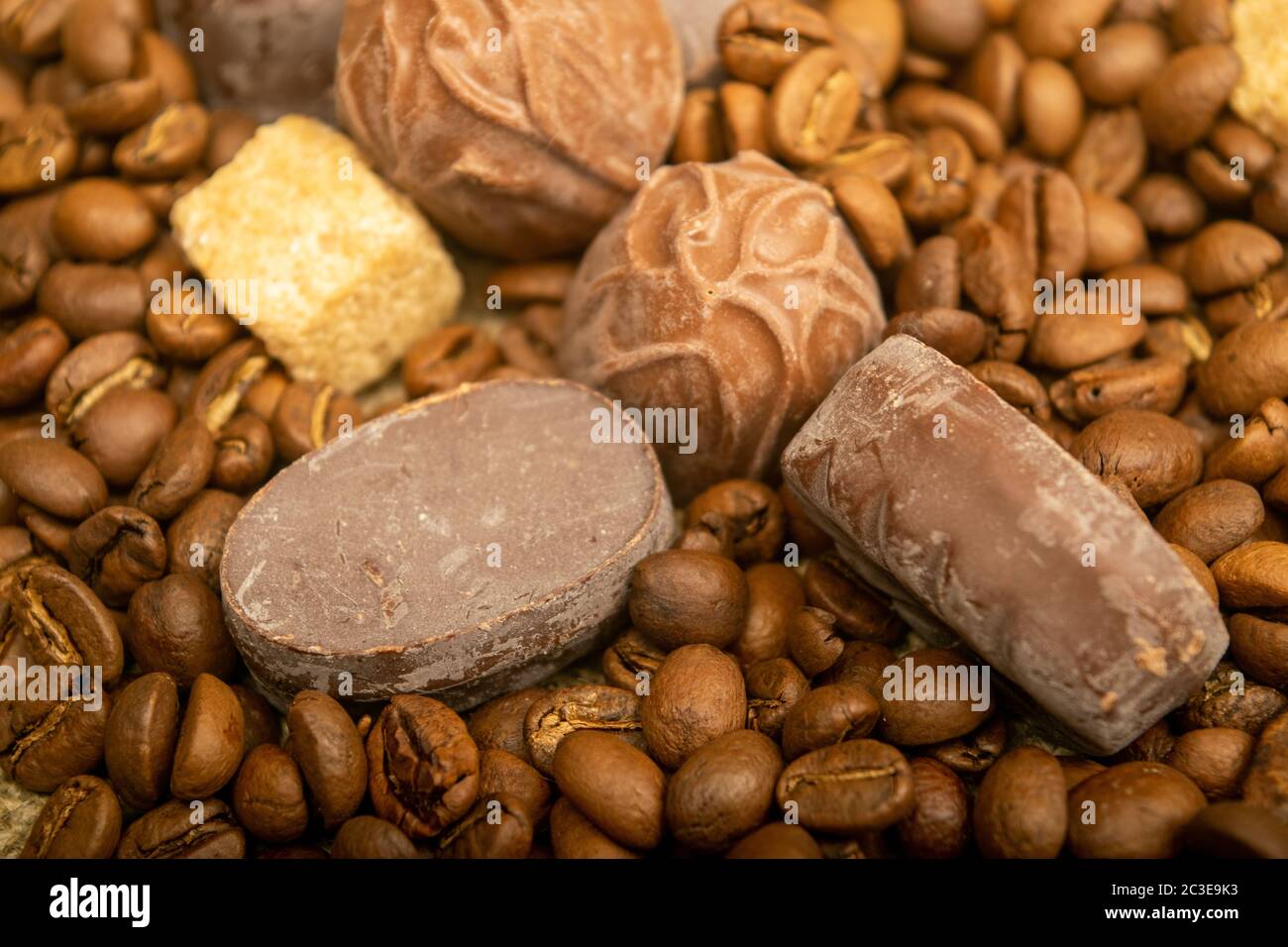 Chocolate, coffee beans, and chunks of brown cane sugar. Close up ...