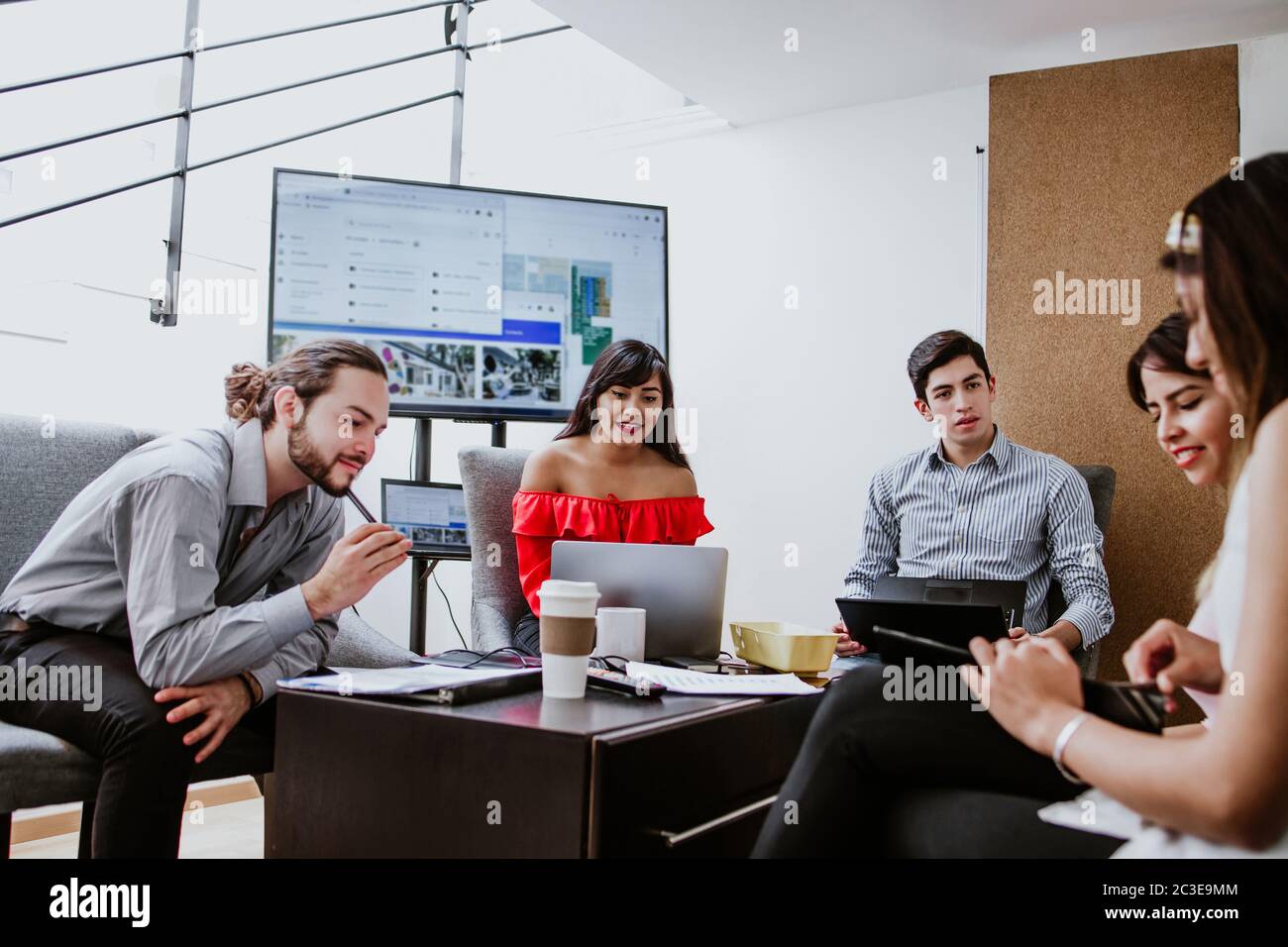 Group of young Latin people teamwork or mexican coworkers working in an ...