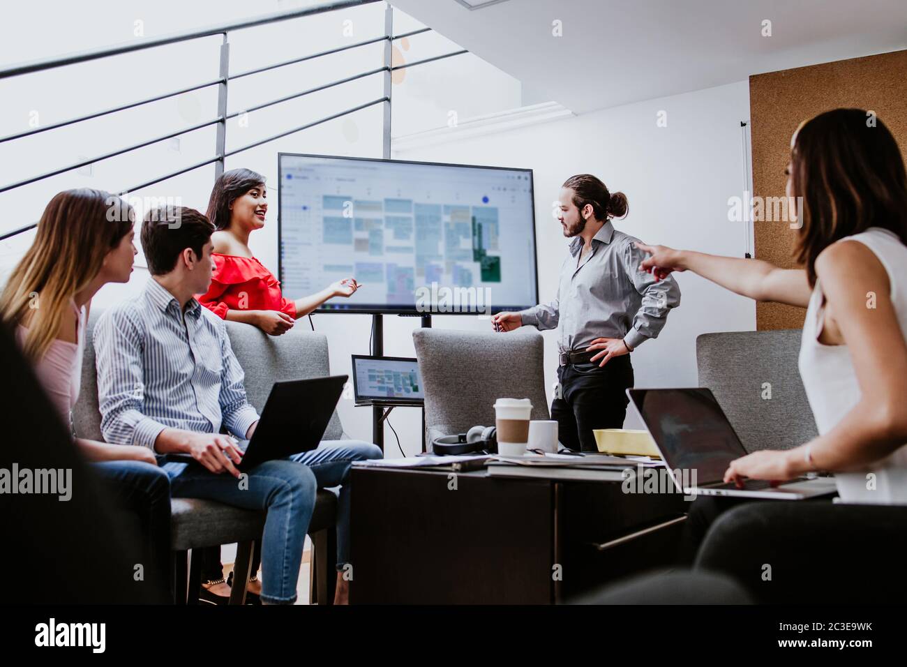 Group of young Latin people teamwork or mexican coworkers working in an ...