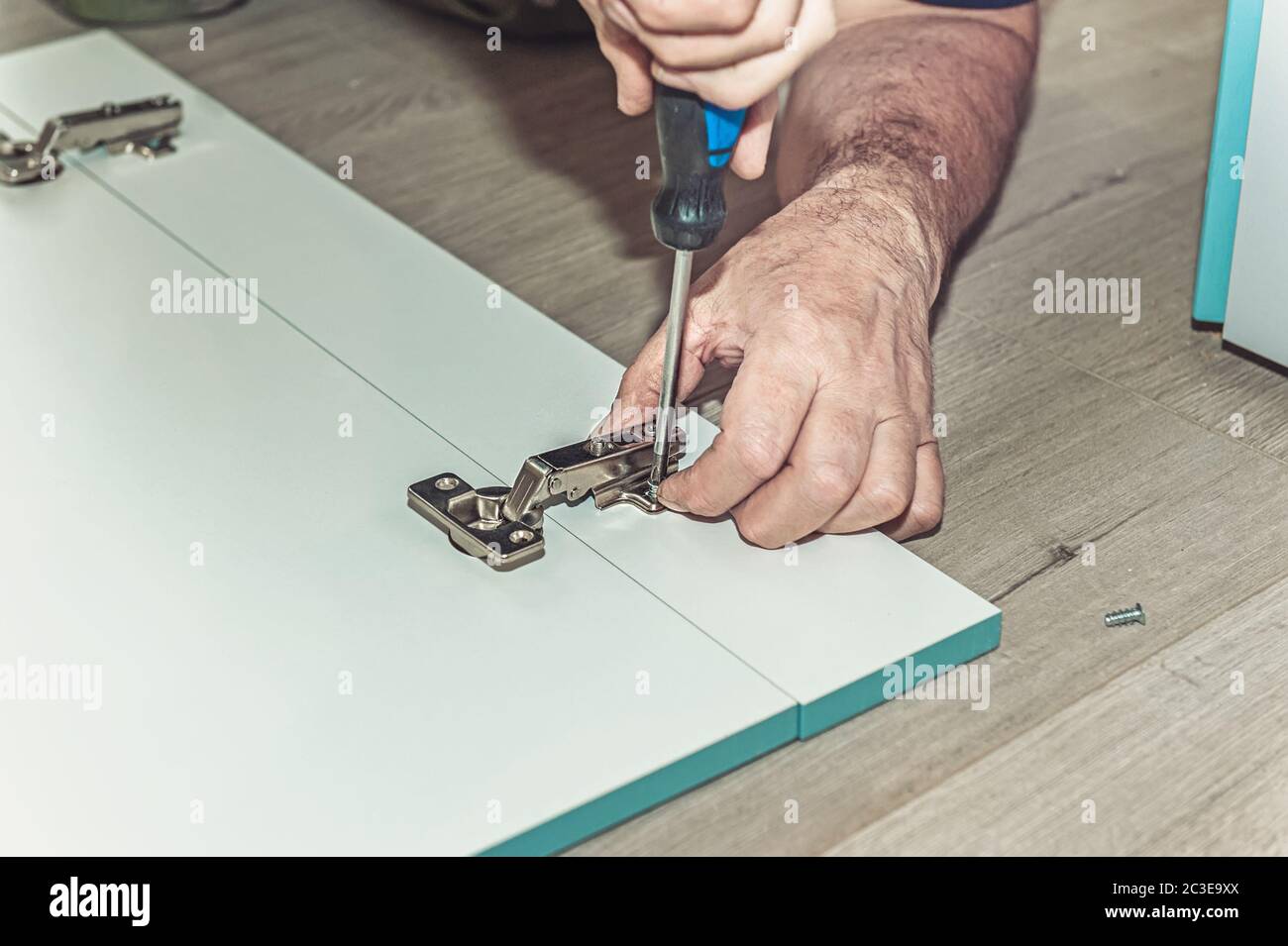 master builds a furniture Cabinet. Mounting for furniture panels ...