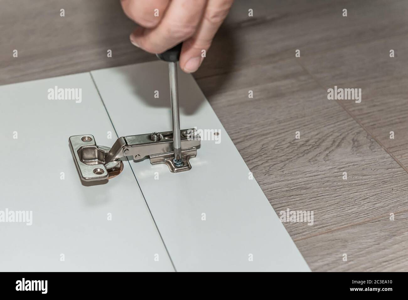 master builds a furniture Cabinet. Mounting for furniture panels ...