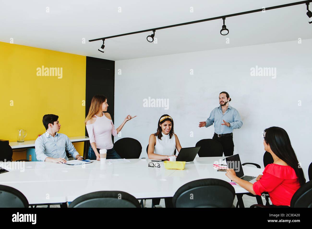 Group of young Latin people teamwork or mexican coworkers working in an ...