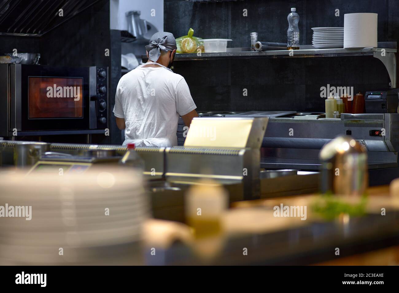 chef preparing food in the kitchen of the restaurant. Bokeh basic ...