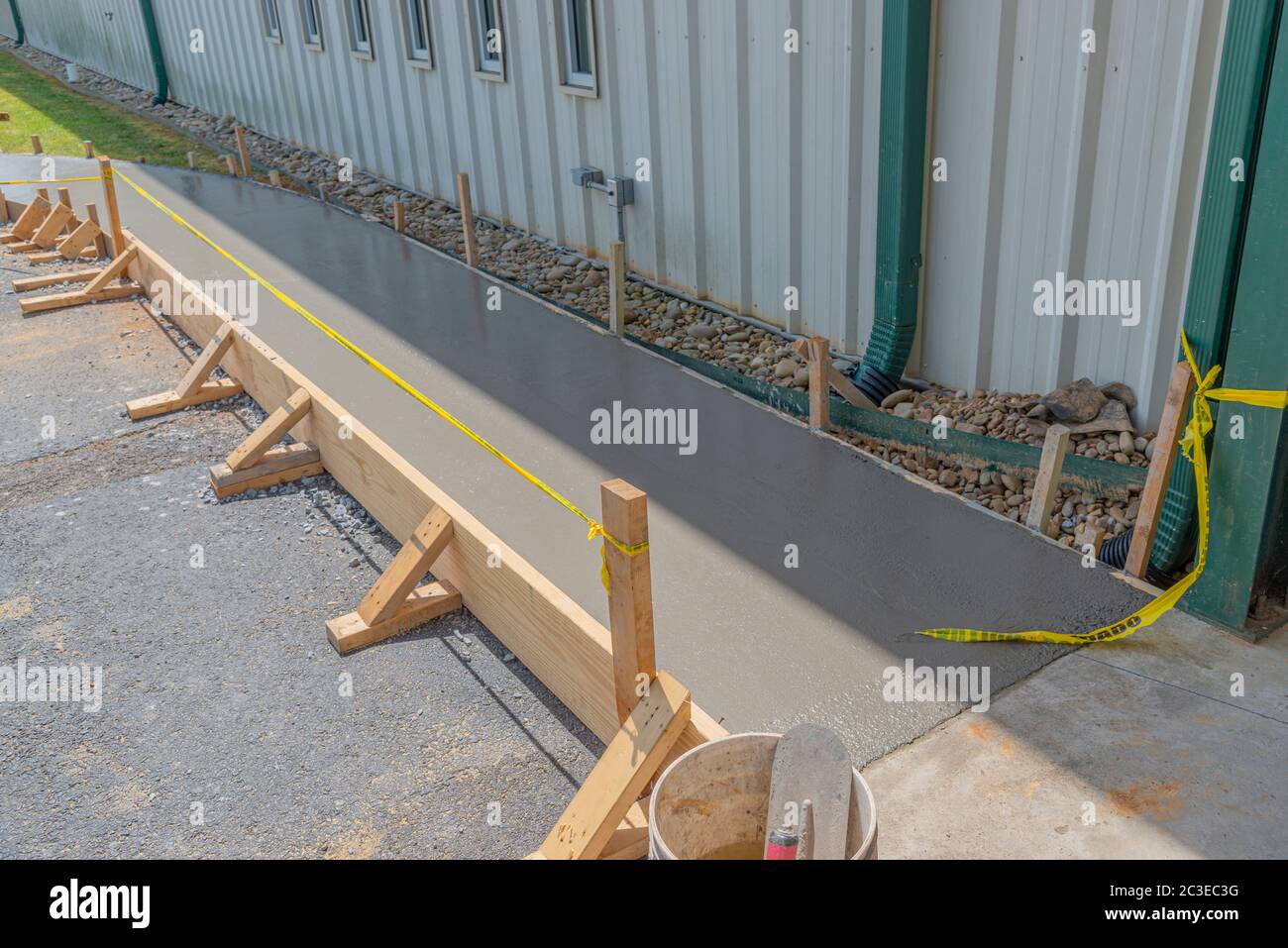 Horizontal shot of a new concrete sidewalk that has just been poured ...