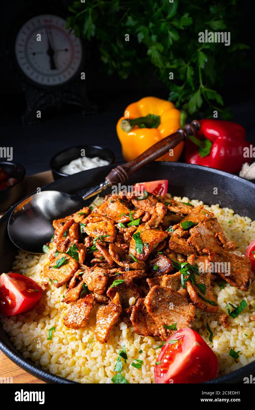 rustic bulgur pans with gratinated gyros and yoghurt Stock Photo - Alamy