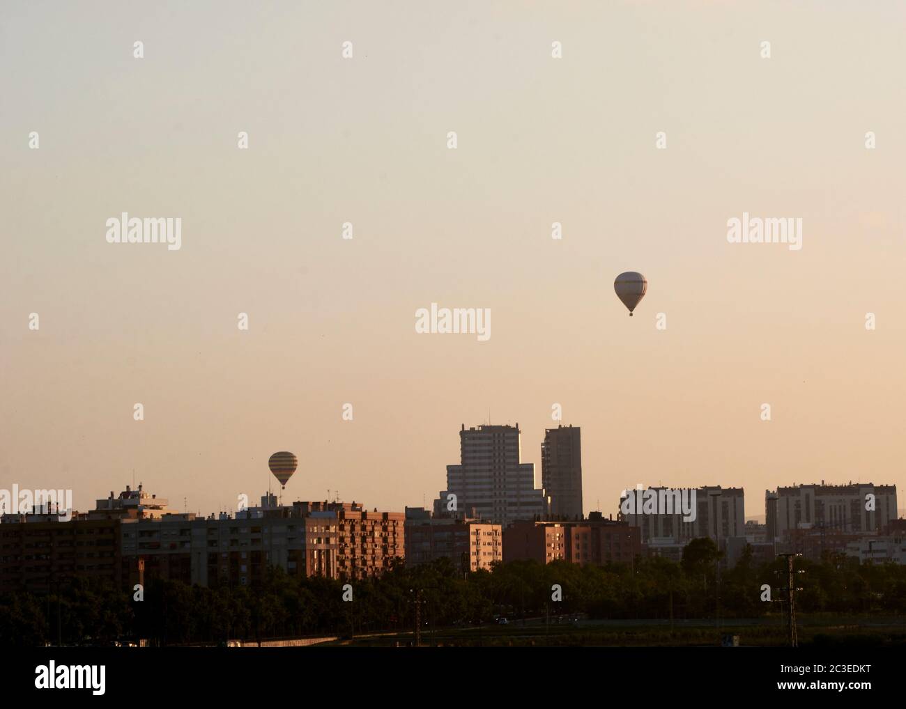Two hot air balloons in the city sky, skyline, blue sky, silhouette ...