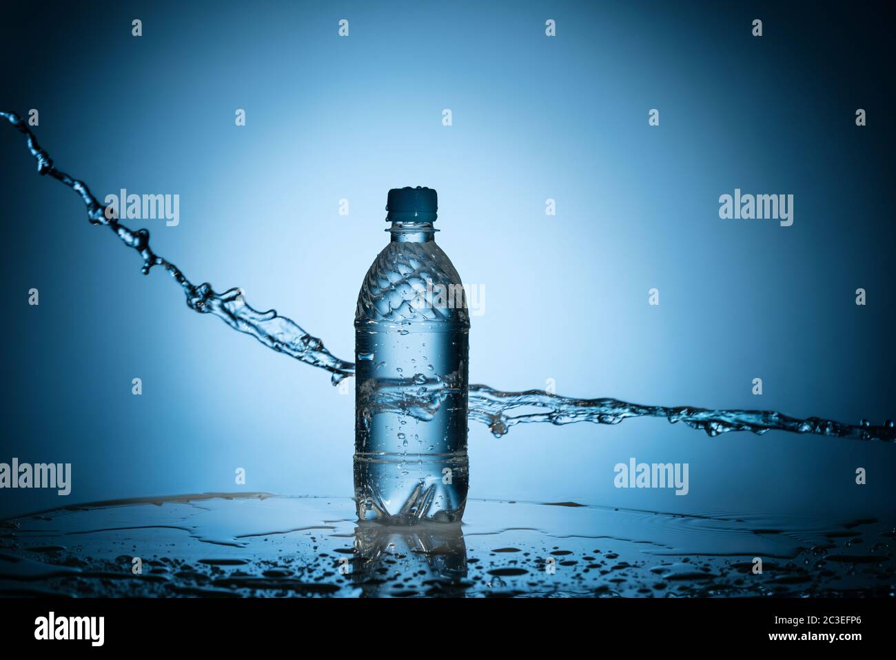 Clean water trickle near transparent plastic bottle Stock Photo - Alamy