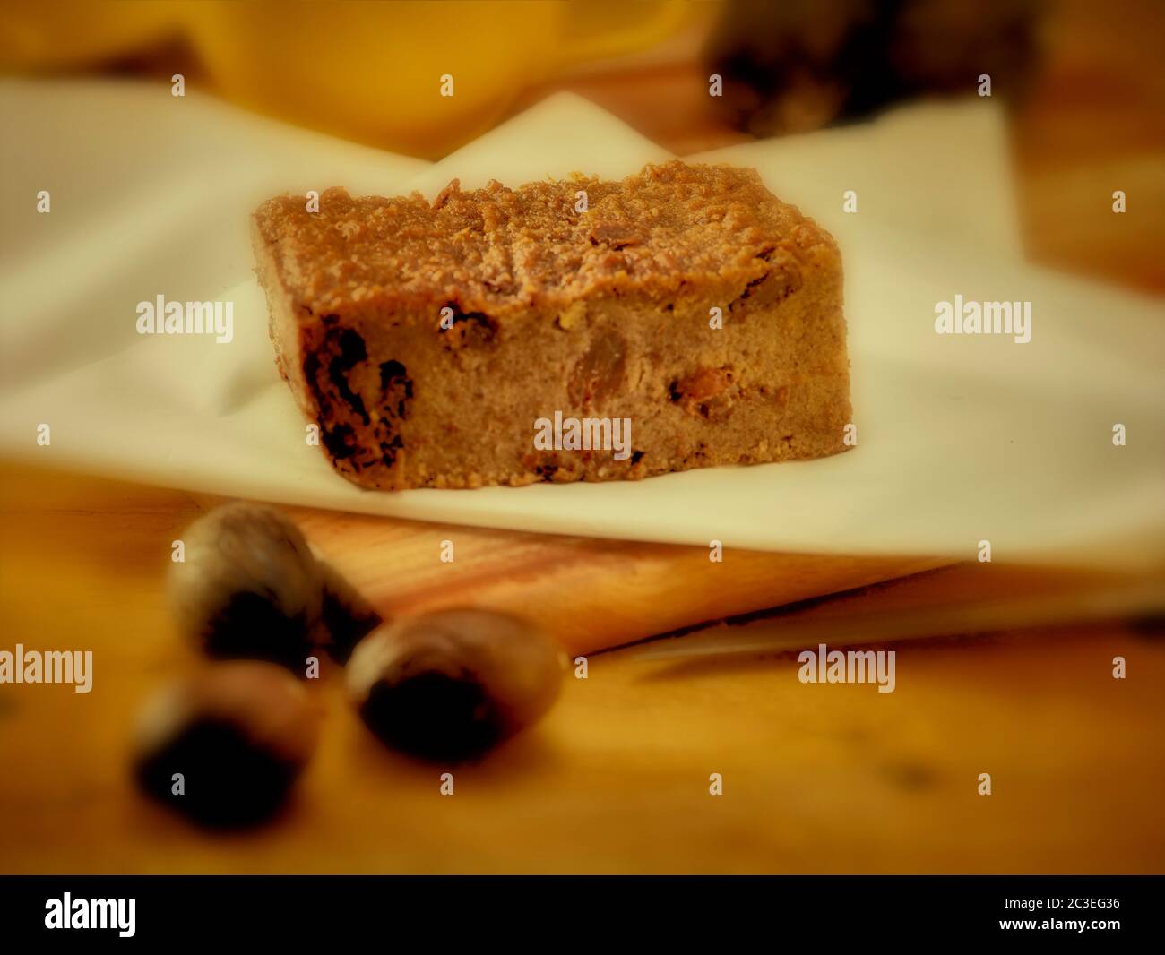 Sliced Bread Pudding and icing sugar on greaseproof paper as if waiting ...