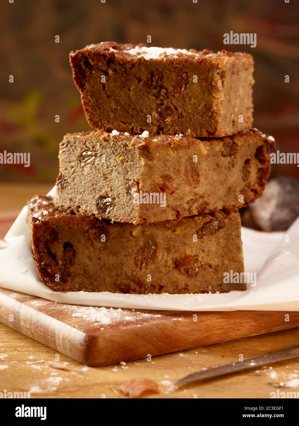 Sliced Bread Pudding on greaseproof paper waiting to be wrapped as a ...