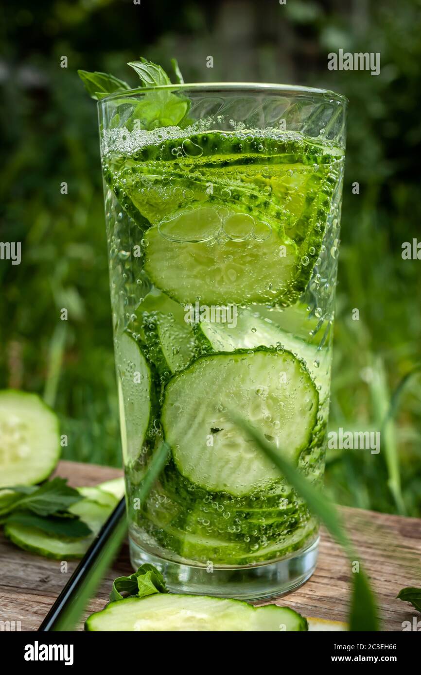A cool, refreshing drink with cucumbers on nature on a hot day Stock ...