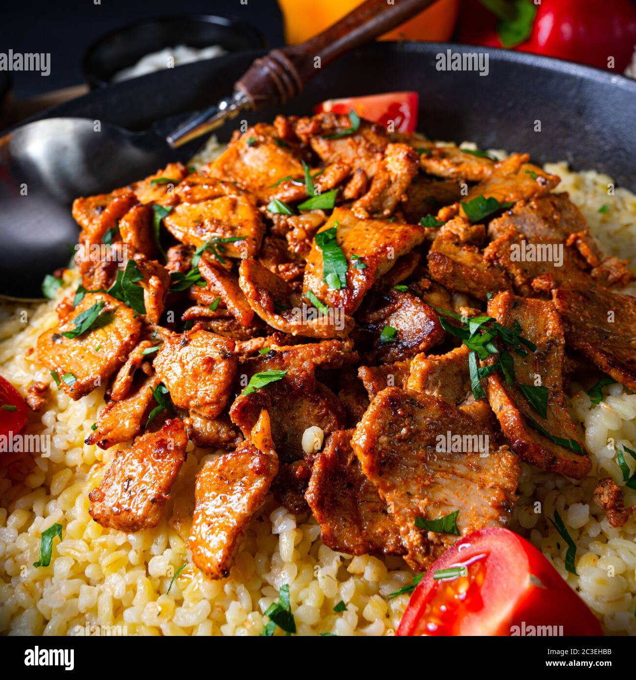 rustic bulgur pans with gratinated gyros and yoghurt Stock Photo - Alamy