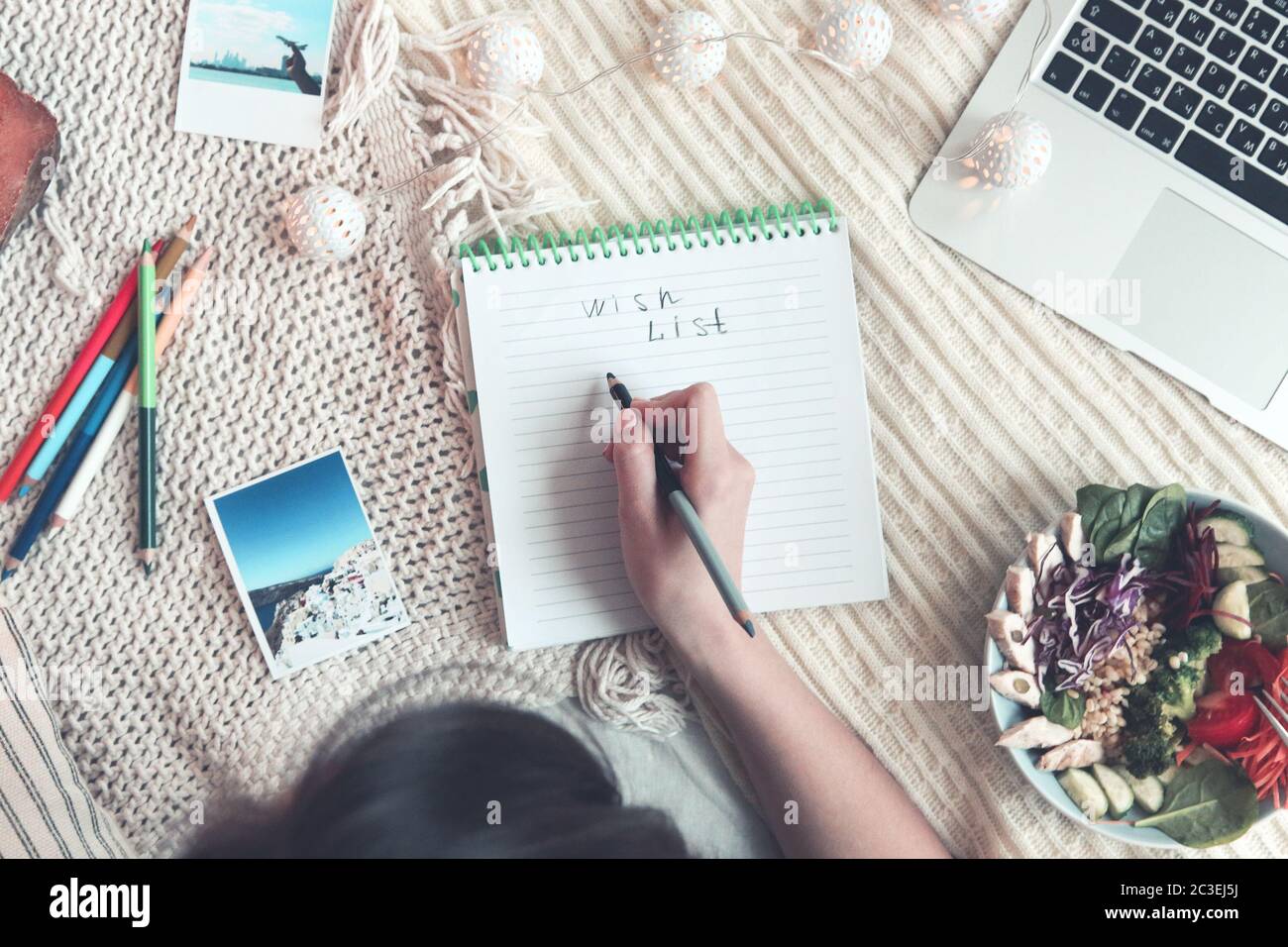 Crop woman creating wish list Stock Photo - Alamy
