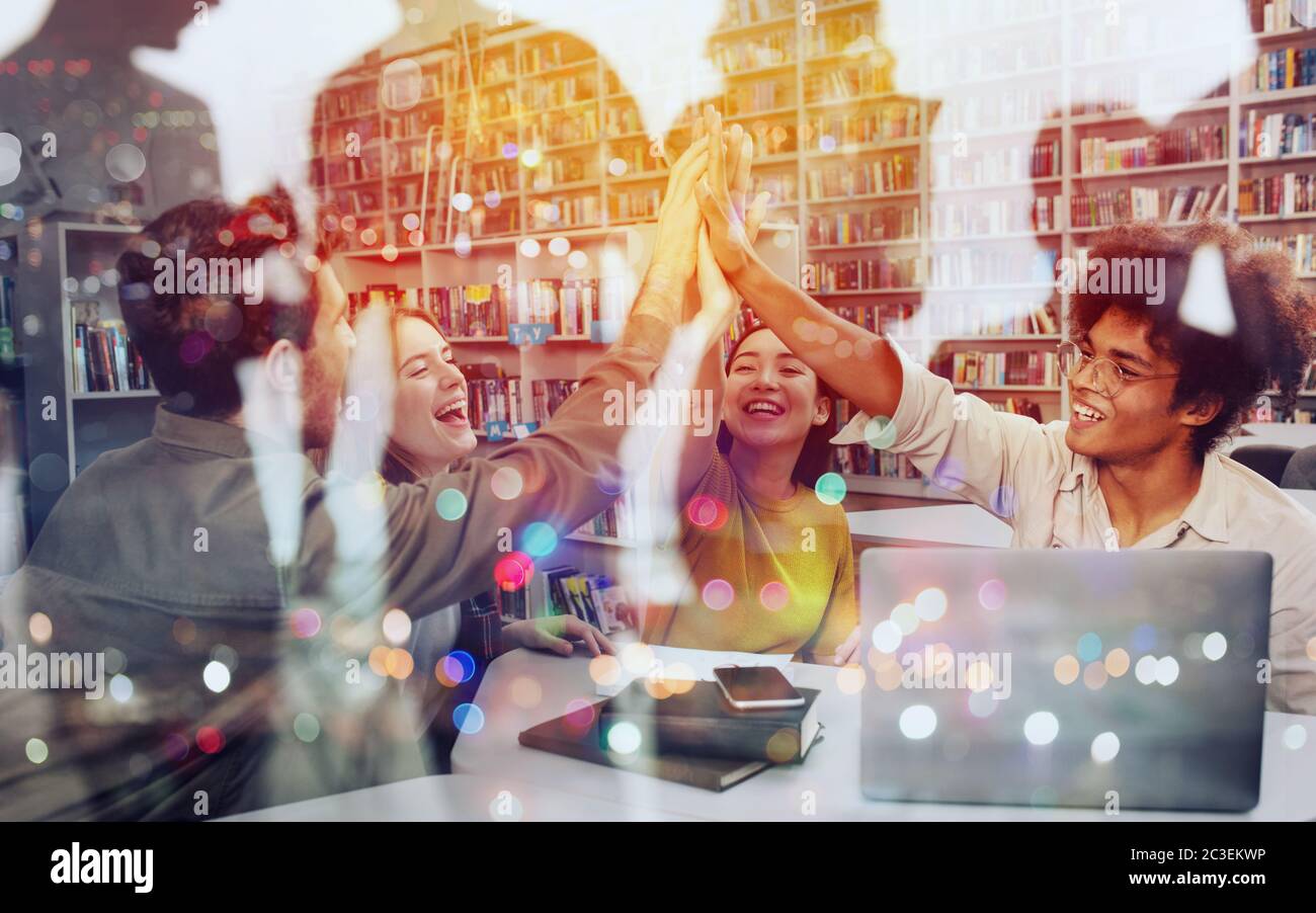 University students putting their hands together. concept of teamwork ...