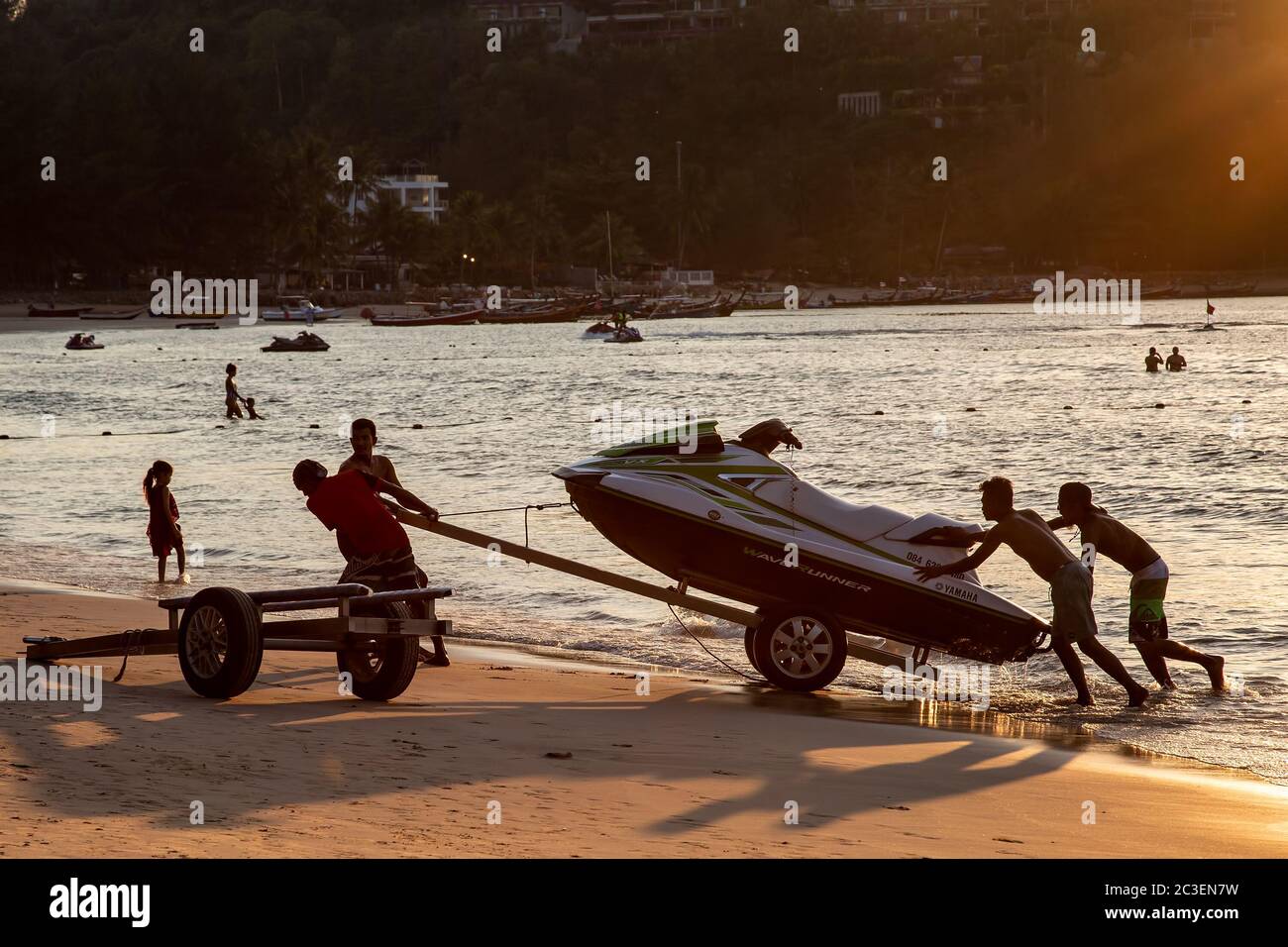 Phuket, Thailand - February 02, 2019: Mens at sunset pull jet ski out ...