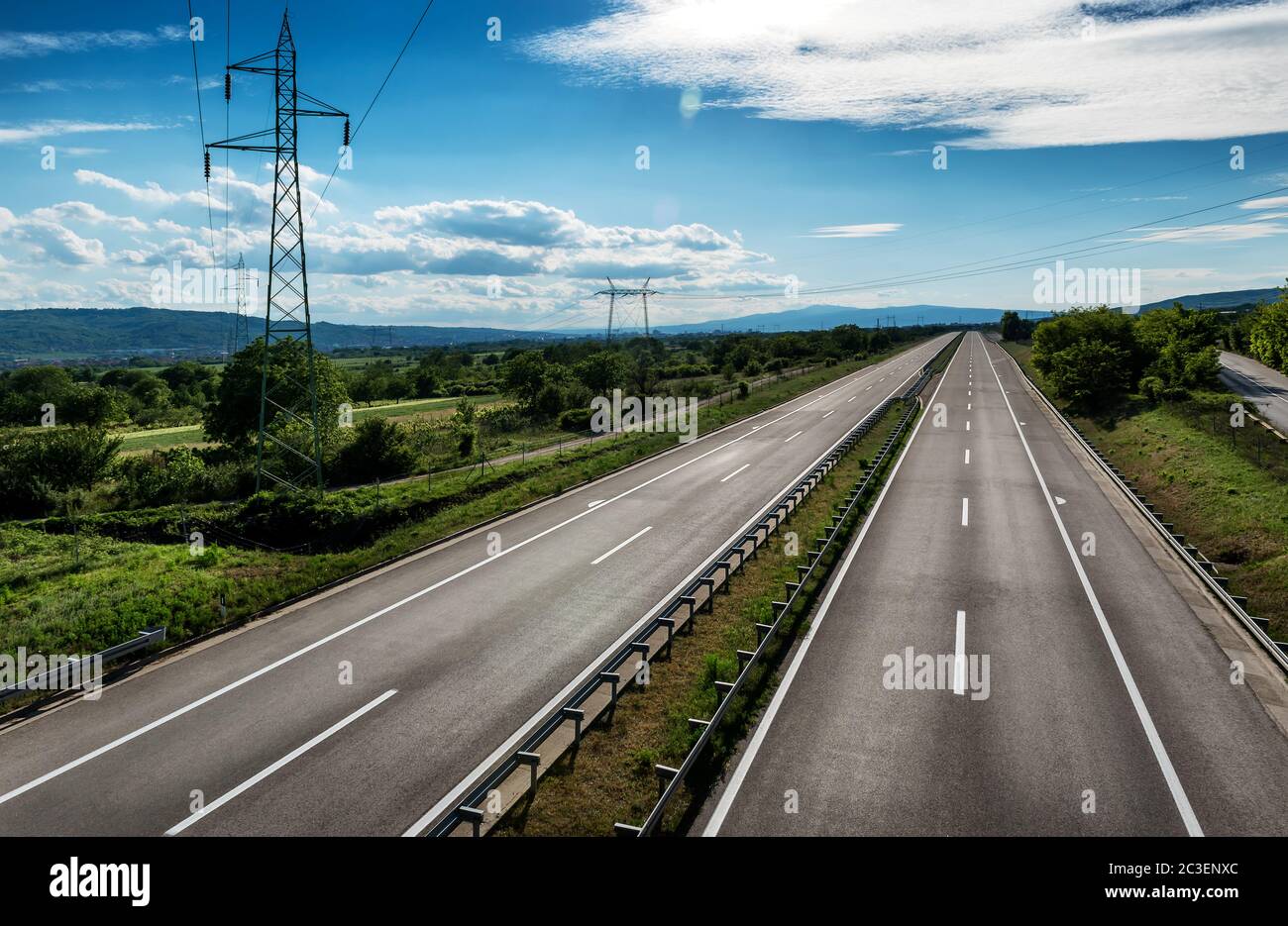 Empty silent Asphalt highway road with beautiful sky and a row of ...