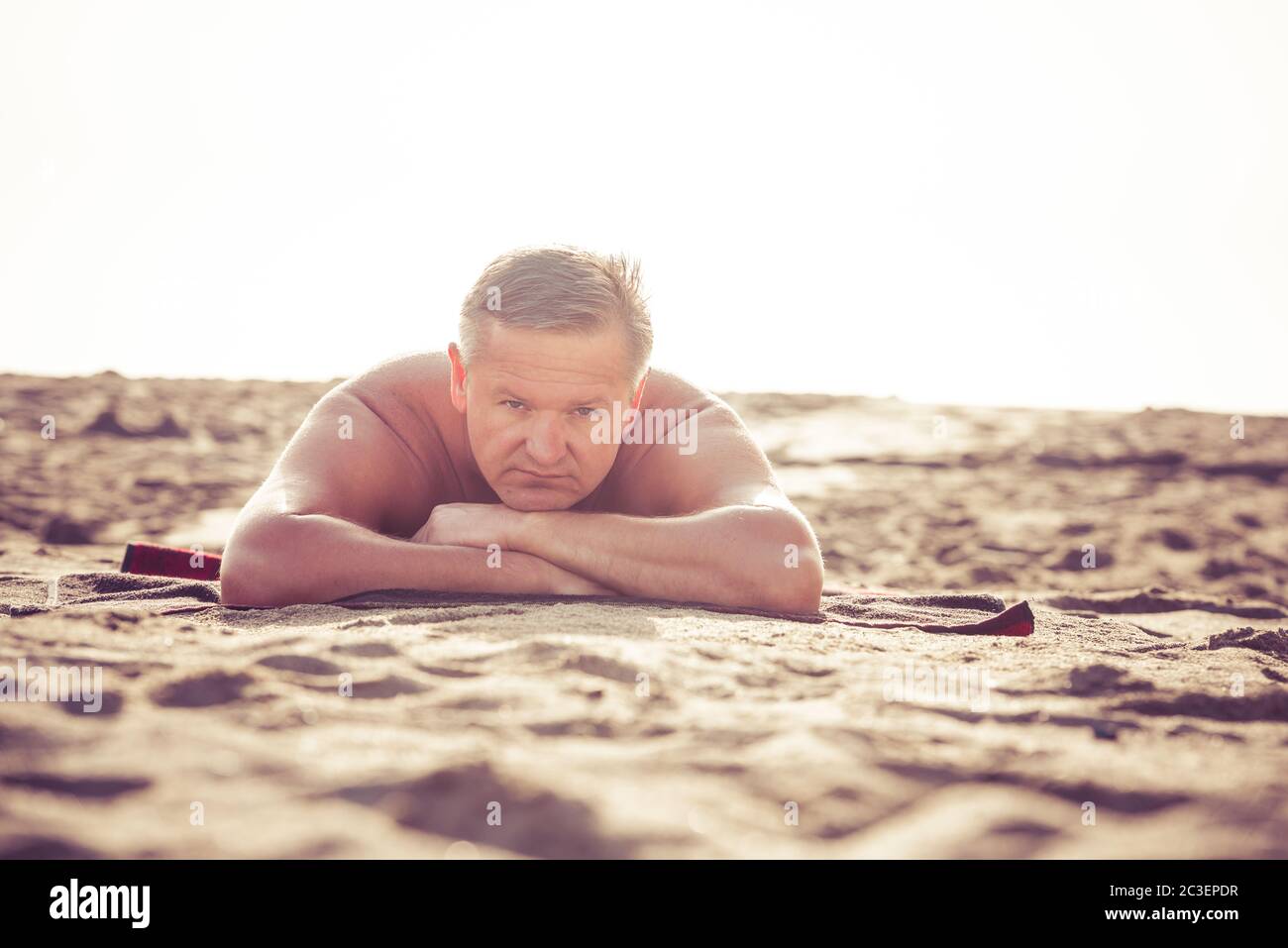 Man on a beach Stock Photo - Alamy