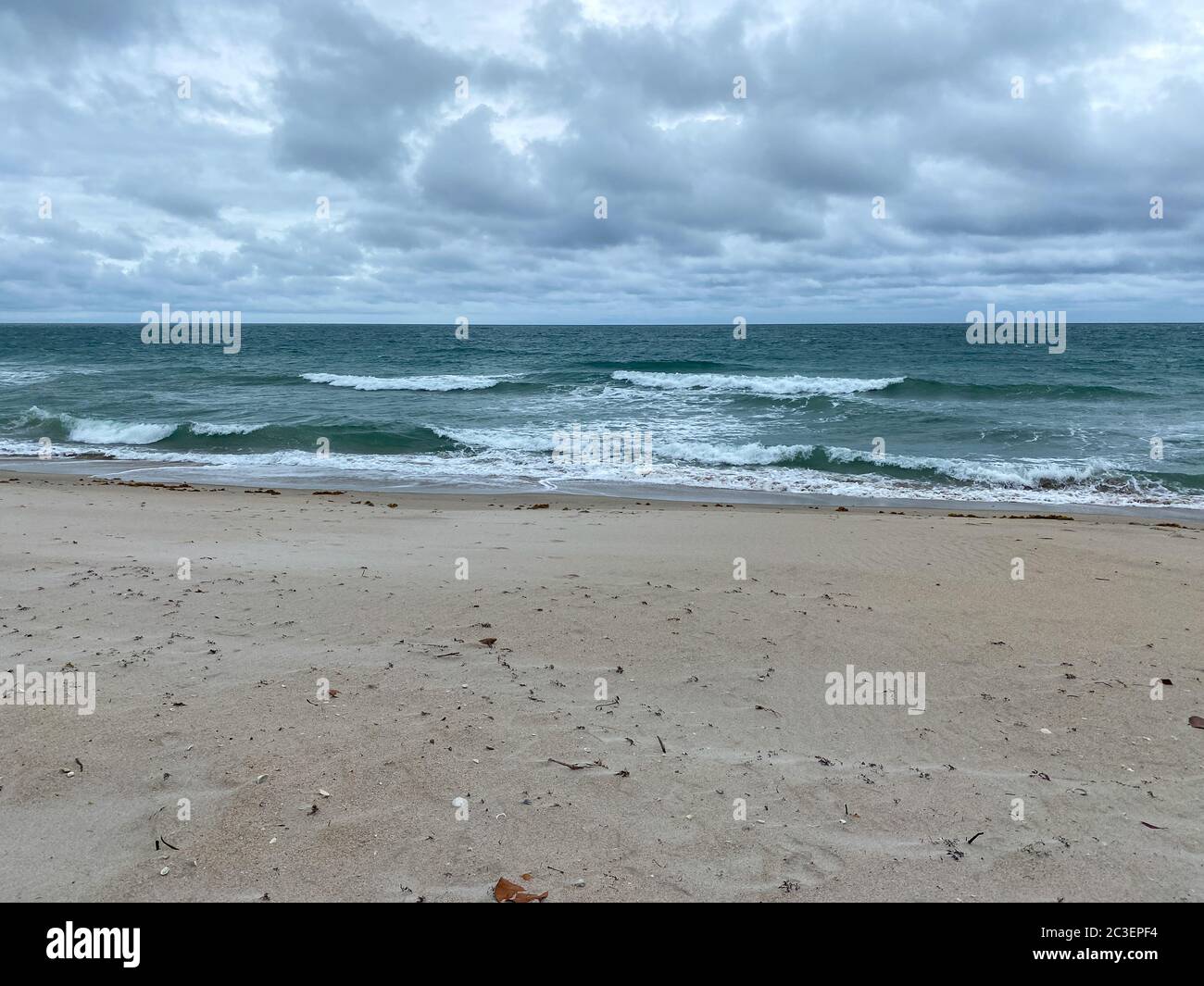 Ocean waves lapping on the beach on a beautiful sunny day along the ...