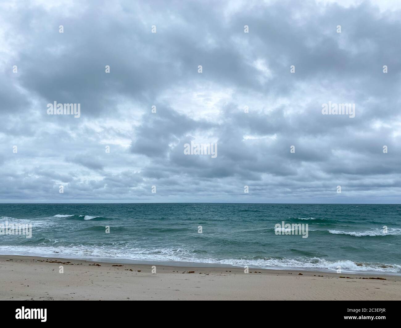 Ocean waves lapping on the beach on a beautiful sunny day along the ...