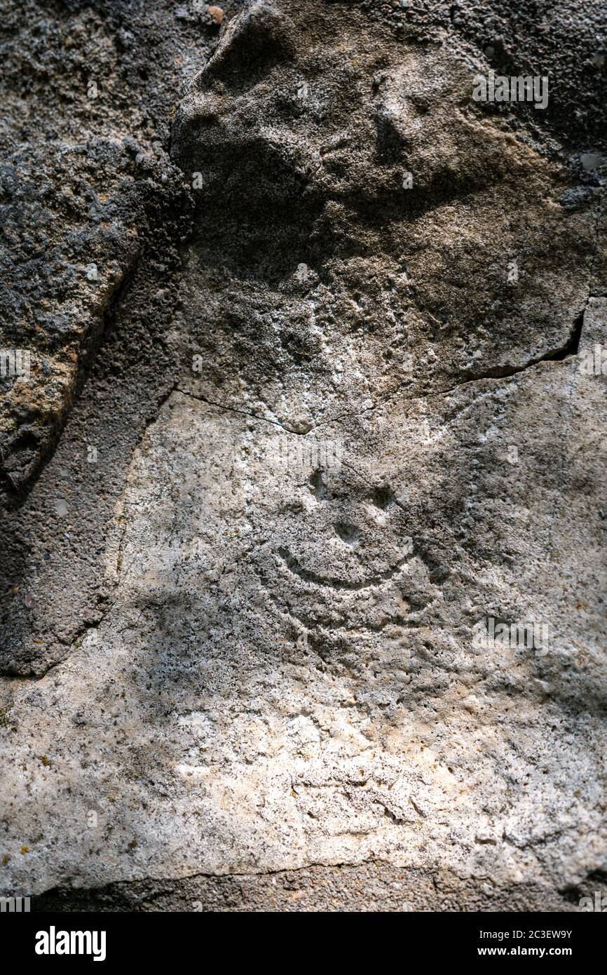 Stone with a painted smile. On the shore, one stone stands out from the ...