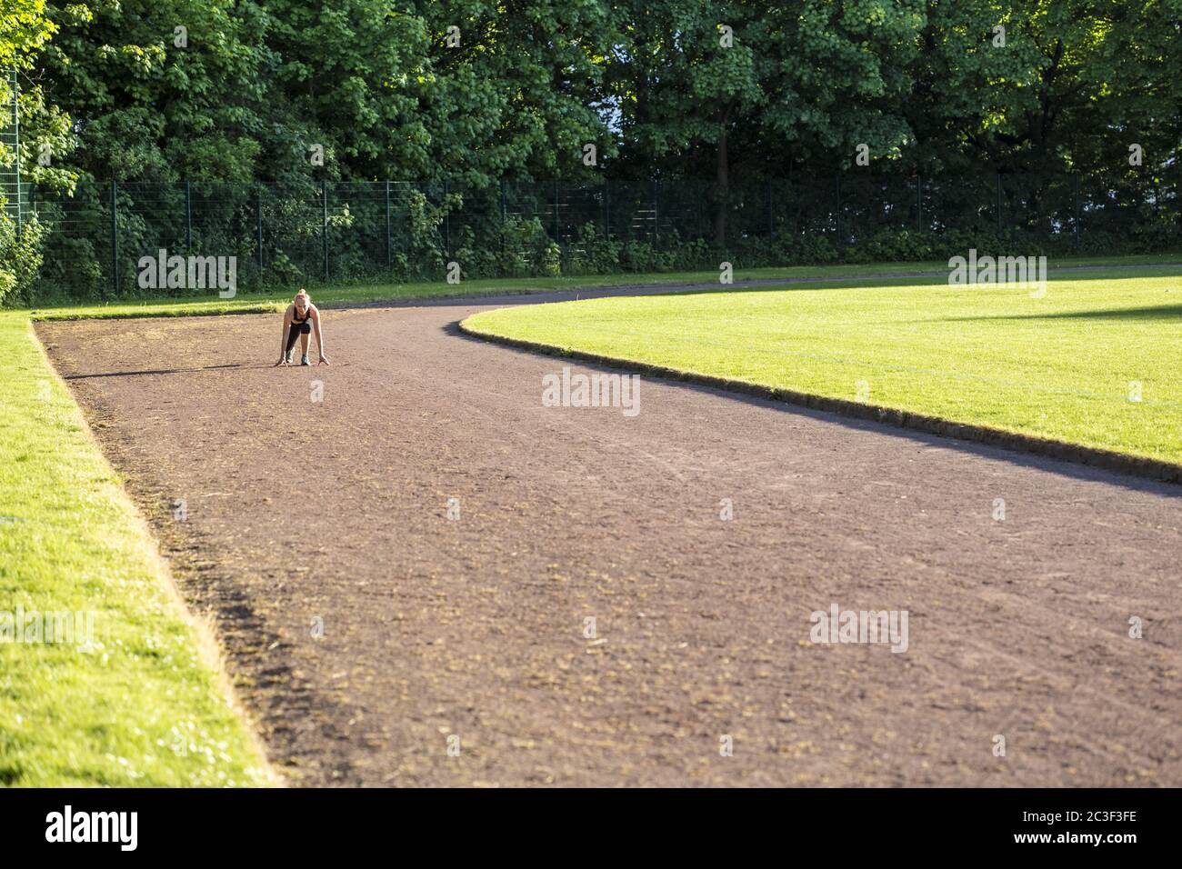 Woman (38) runs on a sand track, Kiel, Schleswig-Holstein, Germany ...