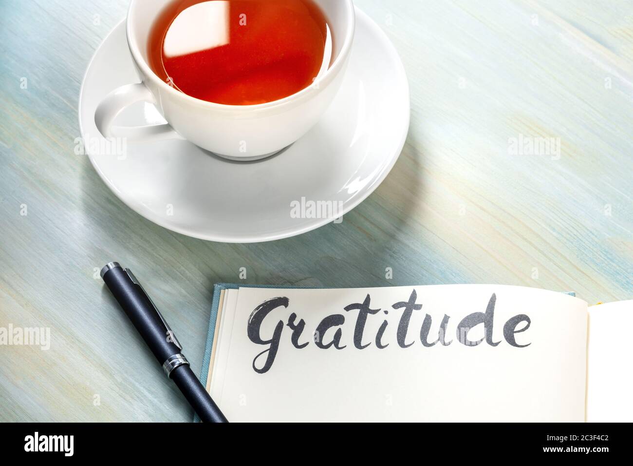 Gratitude journal with a pen and a cup of tea Stock Photo - Alamy