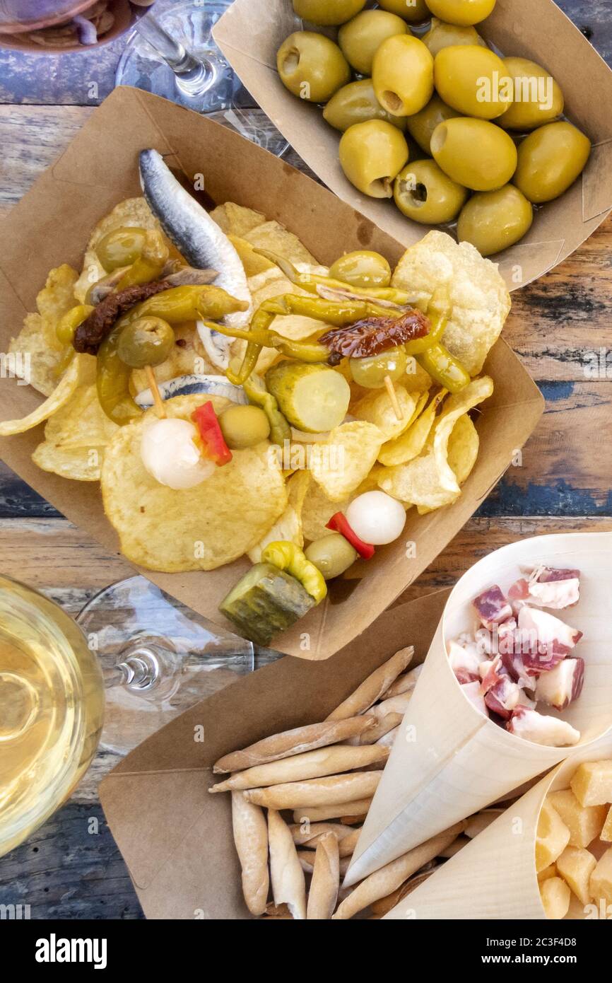 Tapas and pinchos. Spicy gildas with peppers, potato chips, olives ...