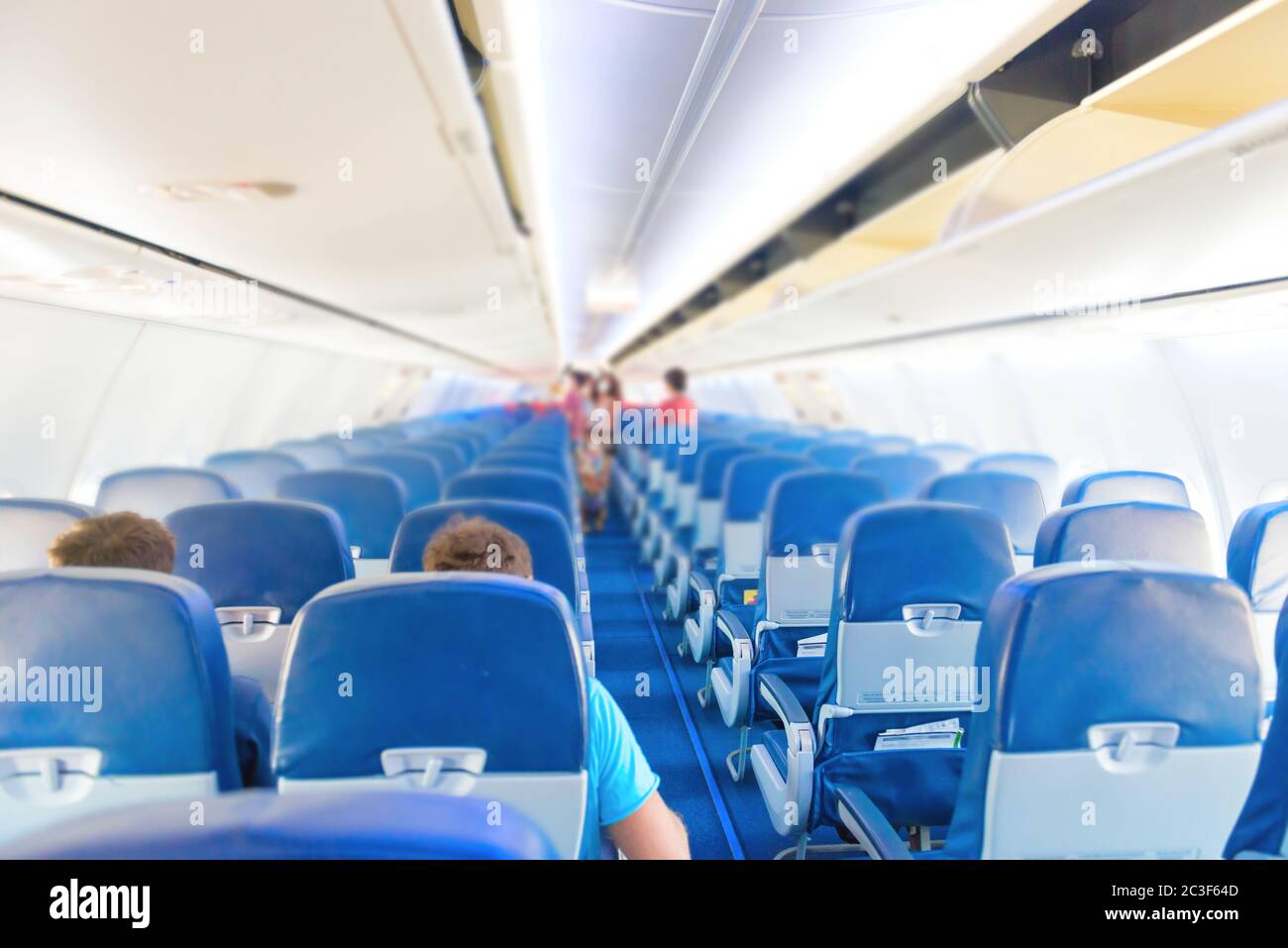 Empty plane interior with few people Stock Photo - Alamy