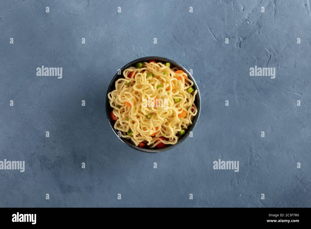 Instant noodles with carrot and scallions, a bowl of vegetable soba ...