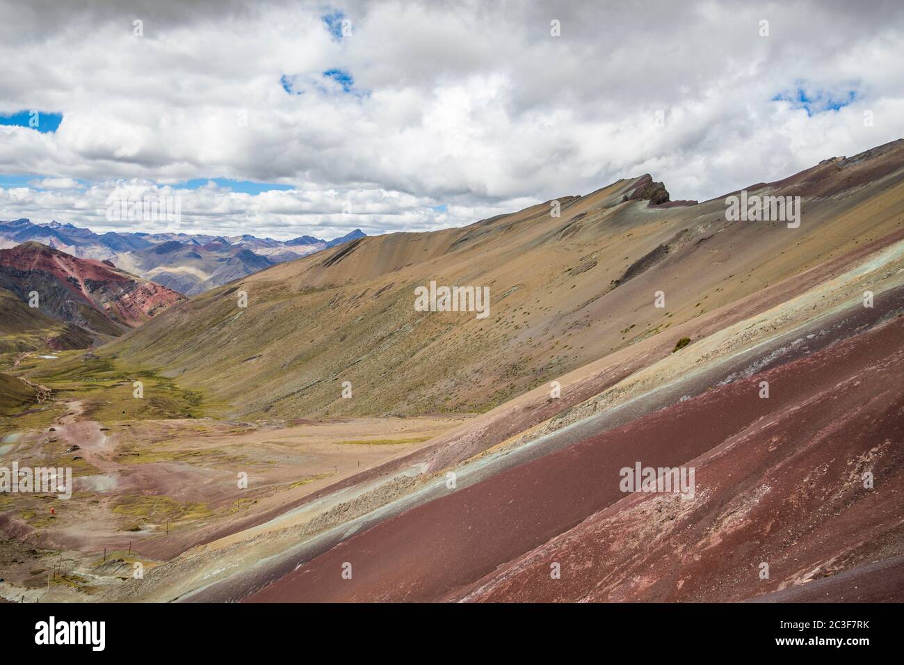 mountains and paths, different colors in the grass, clouds and no ...