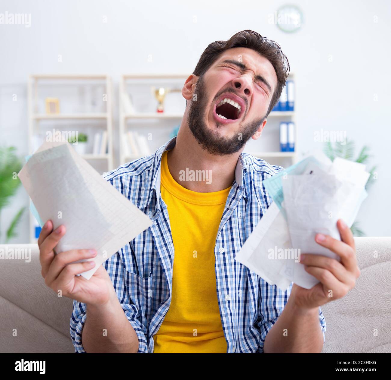 Man angry at bills he needs to pay Stock Photo - Alamy
