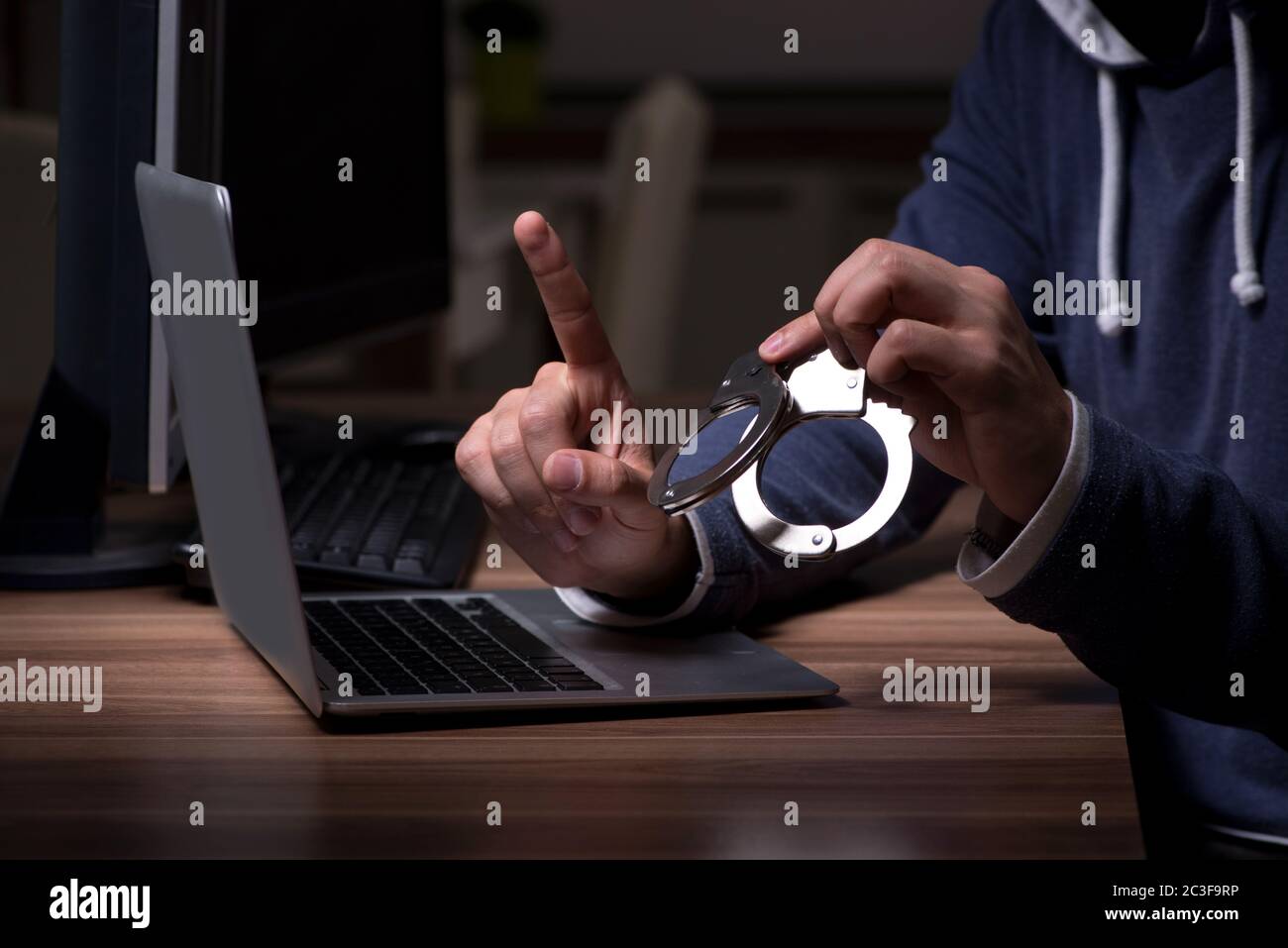 Male hacker hacking security firewall late in office Stock Photo - Alamy