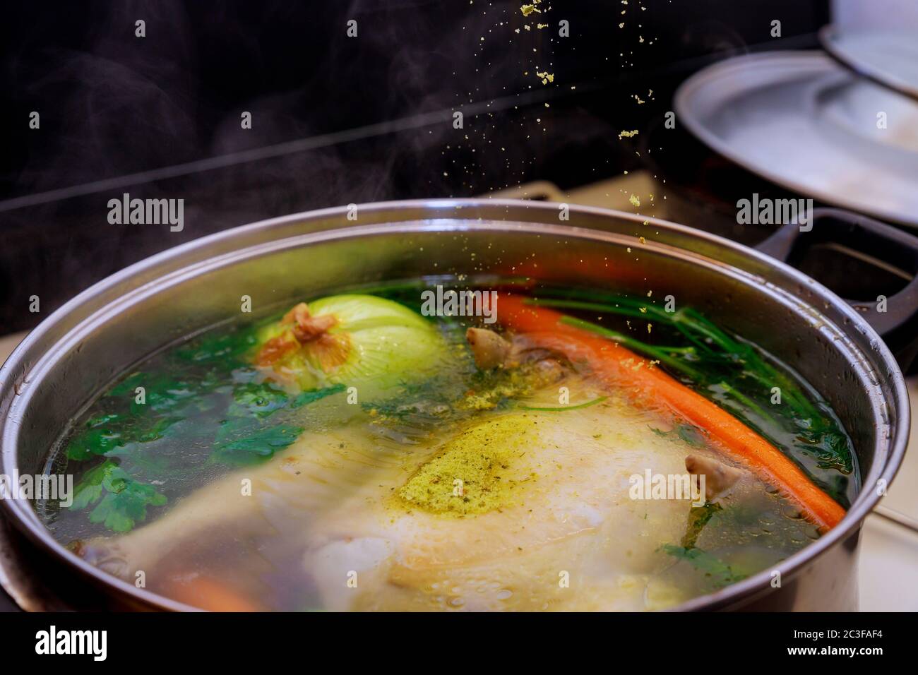 Chicken broth with whole chicken and vegetables in the pot Stock Photo ...
