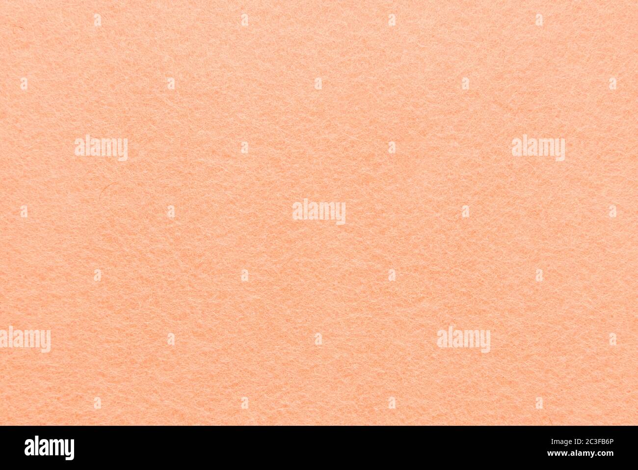 High resolution close up of bright peach felt fabric texture of rough fleecy fabric of peach ...
