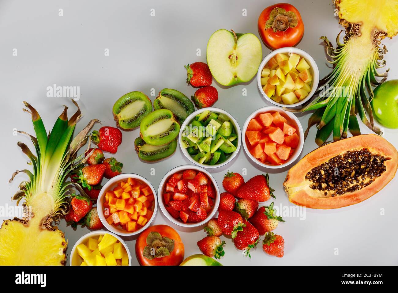 Tropical colorful whole and cut fruits on white background Stock Photo ...