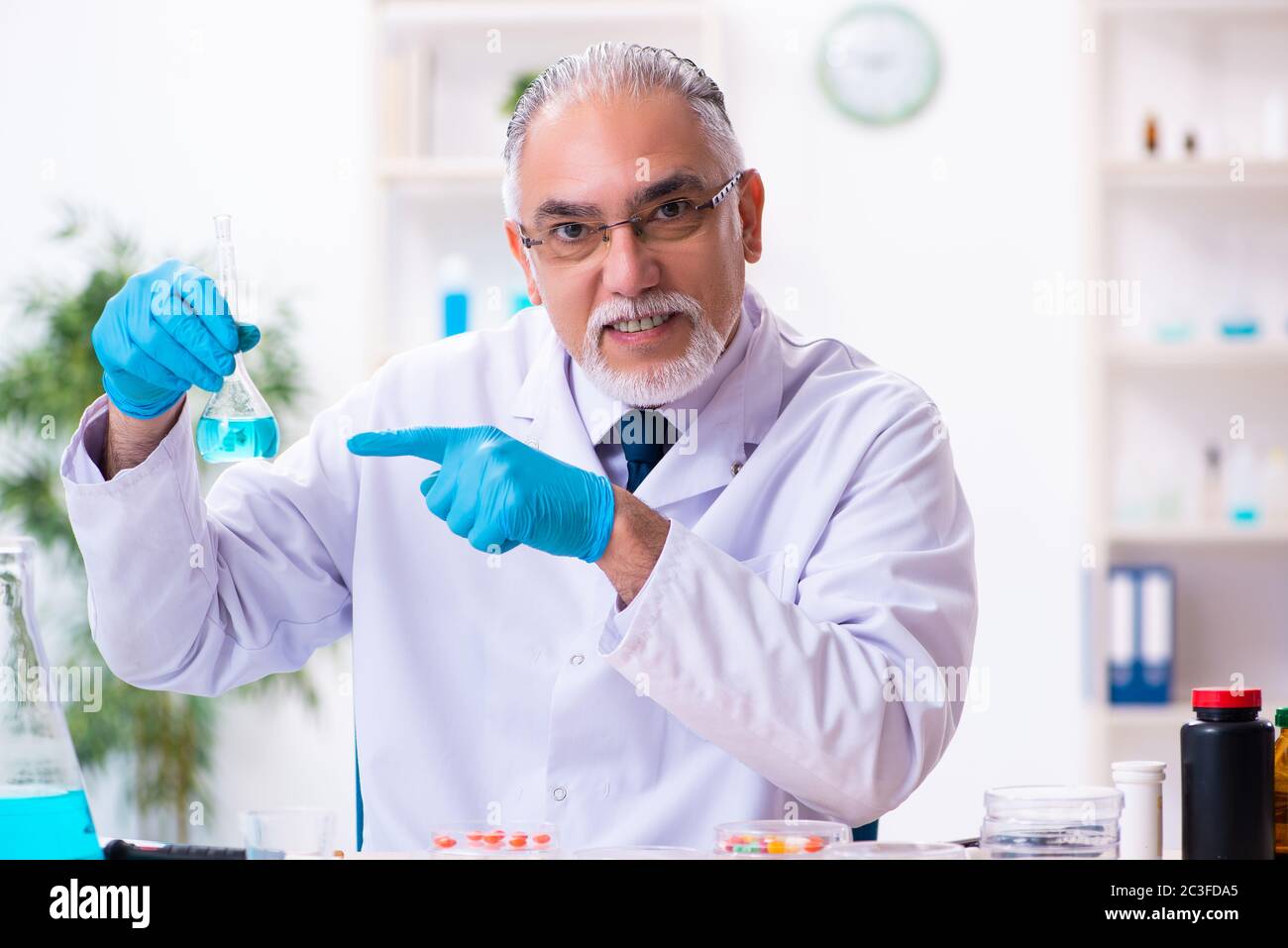Old male chemist working in the lab Stock Photo - Alamy