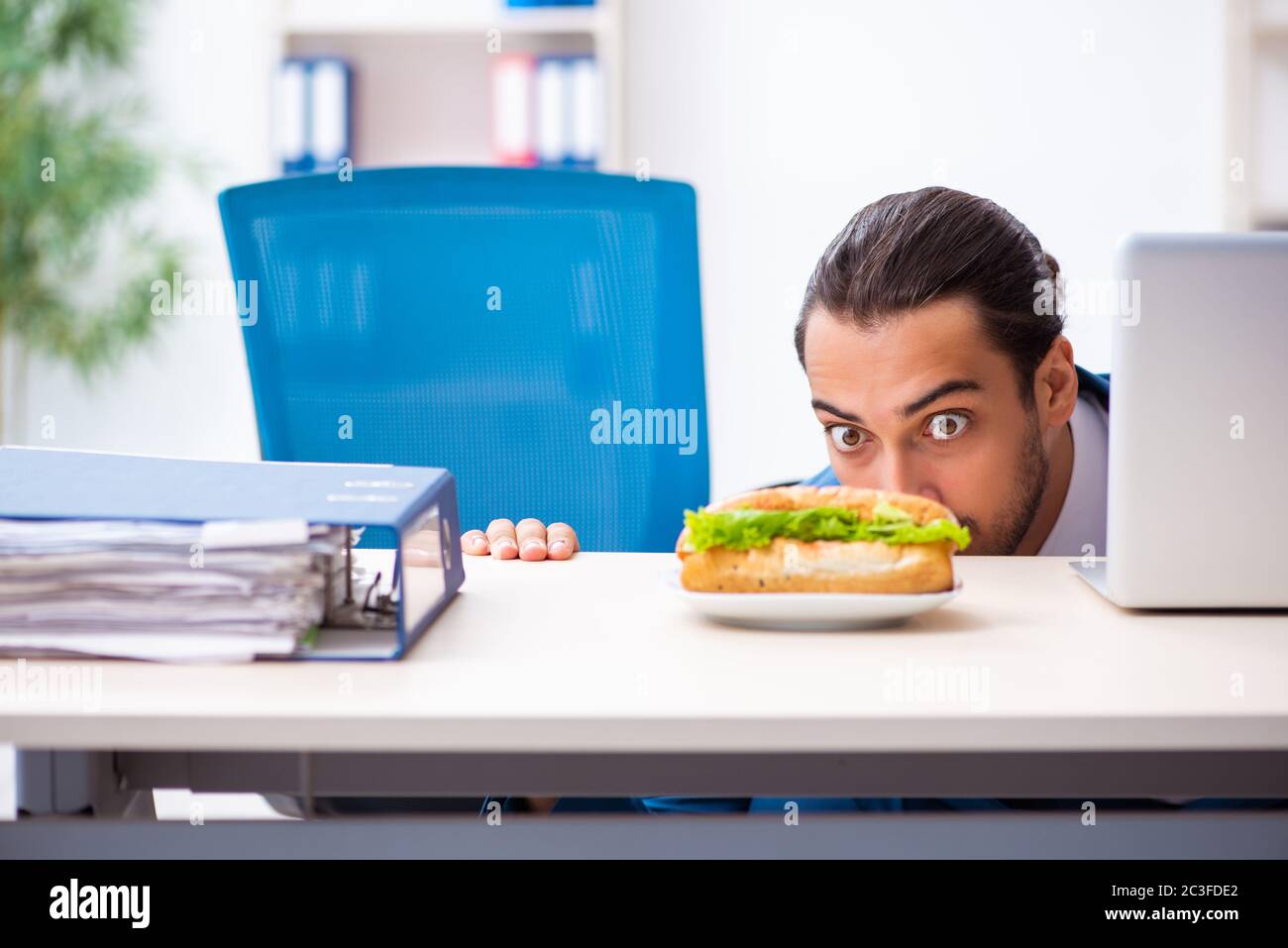 Male office worker having snack hi-res stock photography and images - Alamy