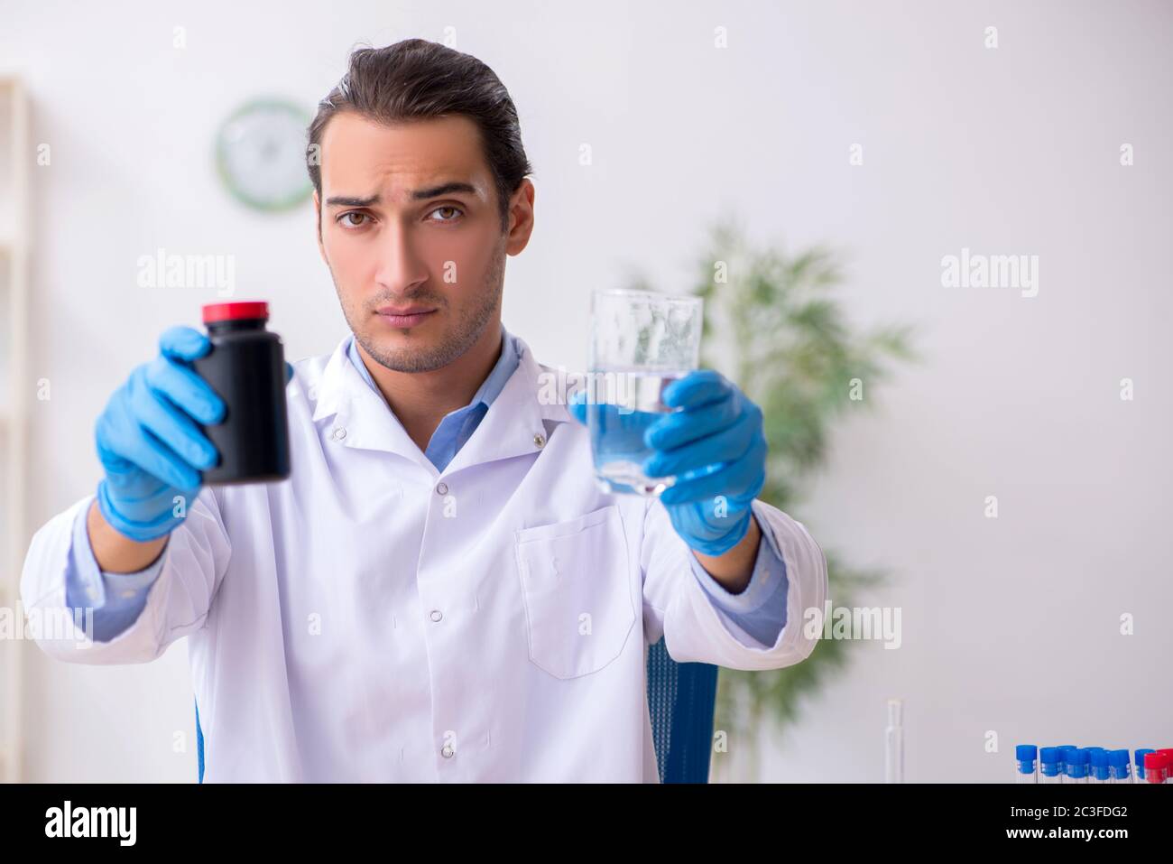 Young male lab assistant in drug synthesis concept Stock Photo - Alamy