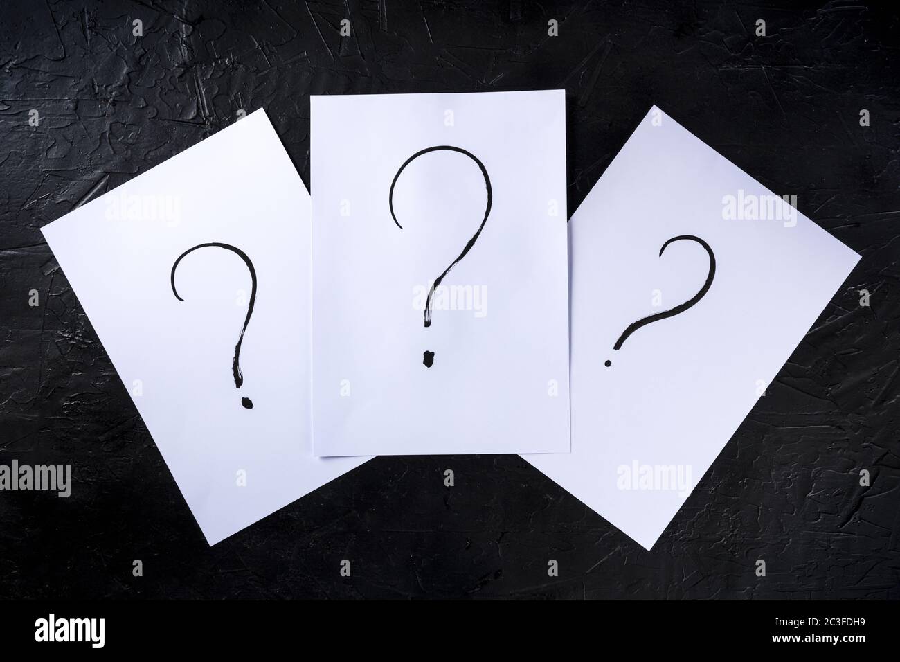 Question marks, written in ink on a piece of standard office paper ...