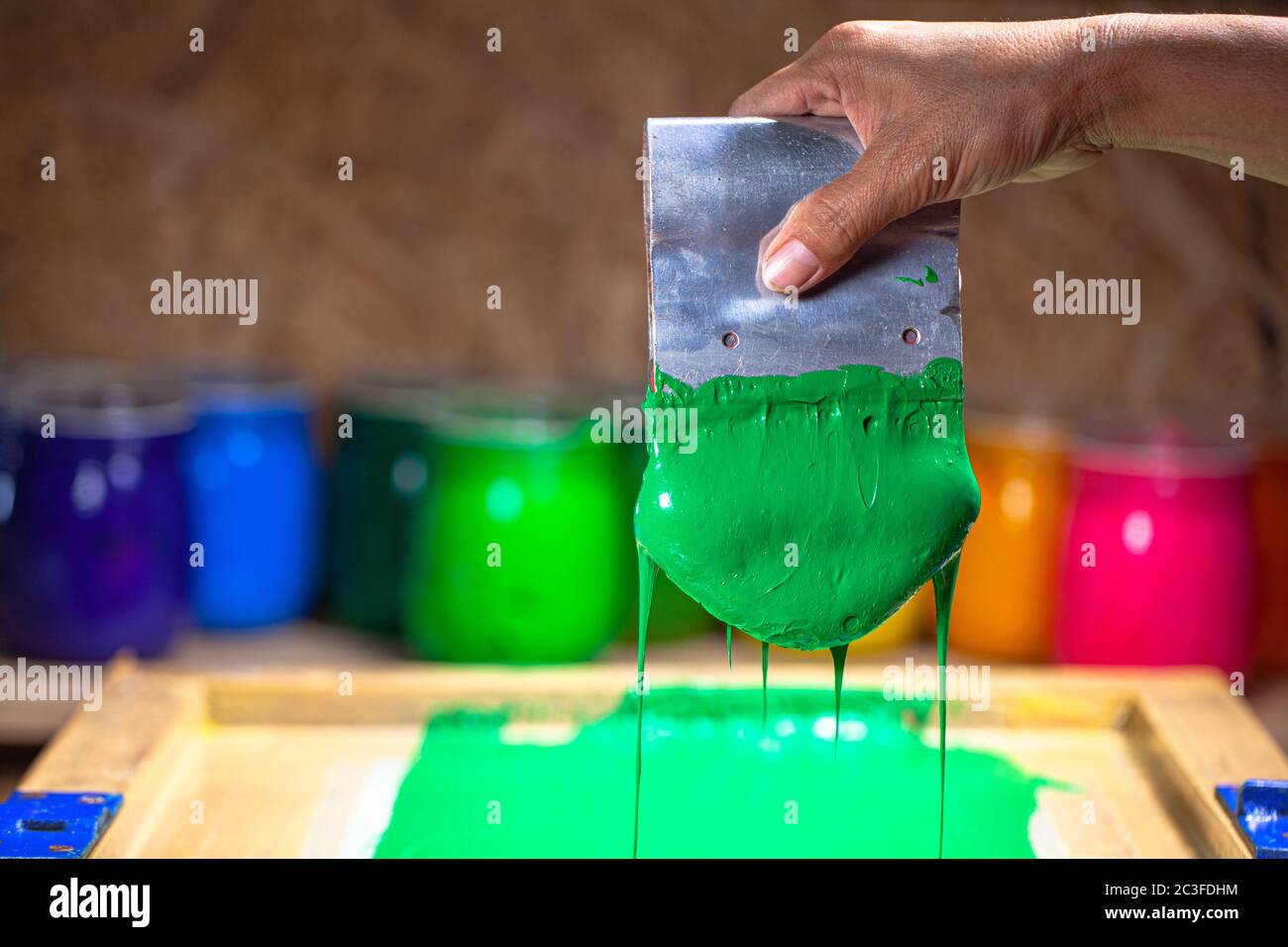 green color dripping from hand screen printing during printing tee ...