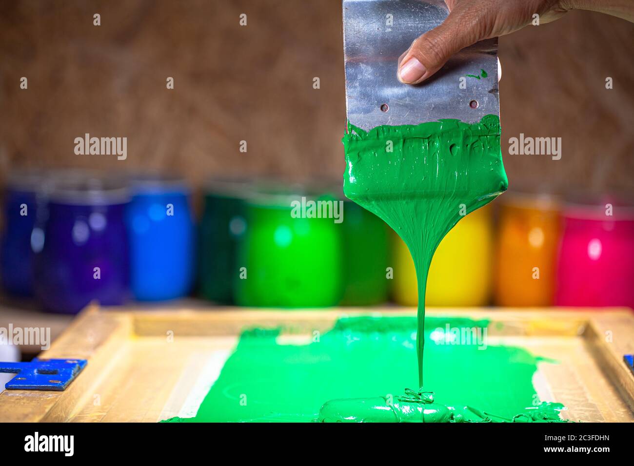 green color dripping from hand screen printing during printing tee ...