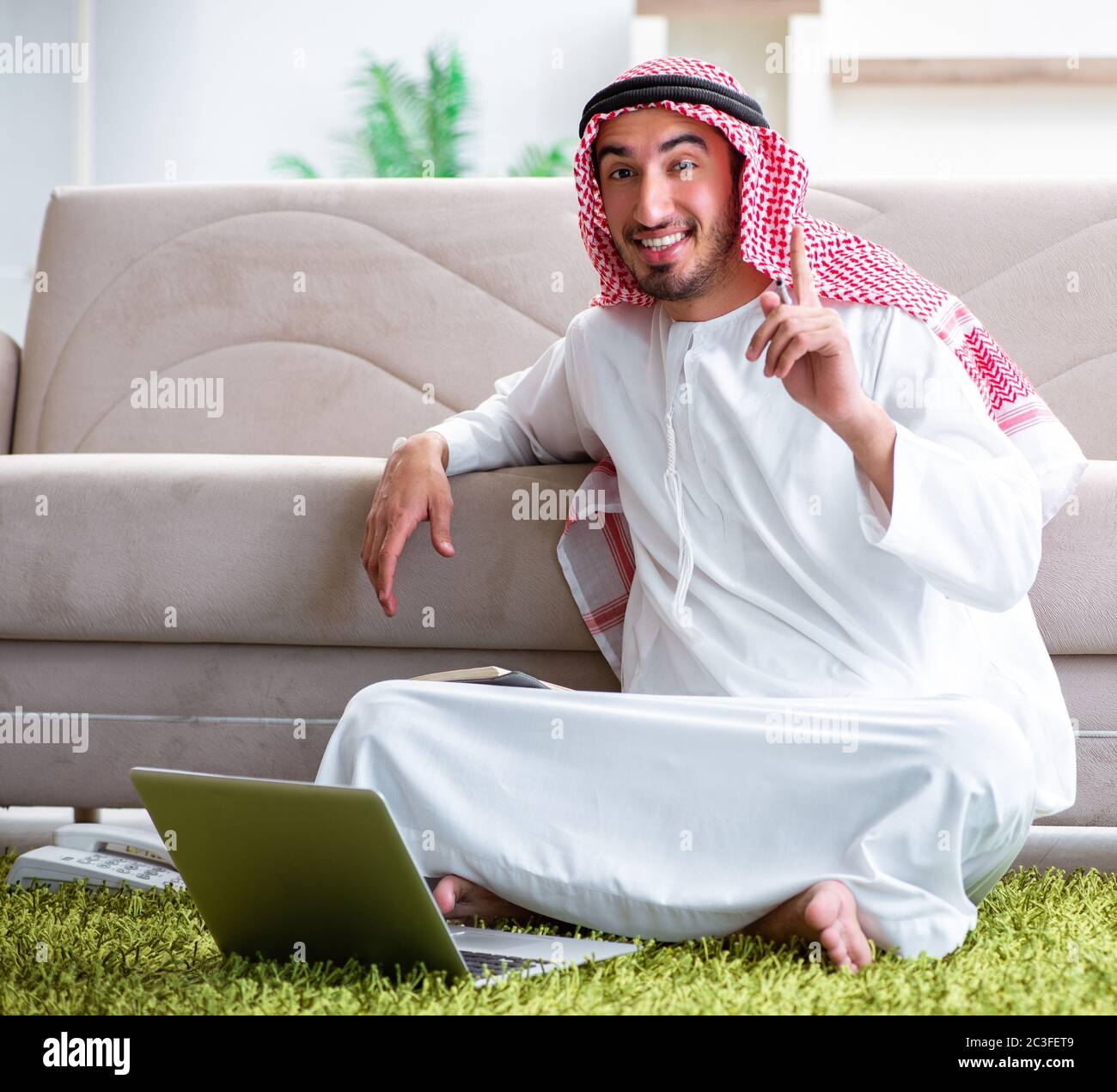 Arab man working at home on his work Stock Photo - Alamy