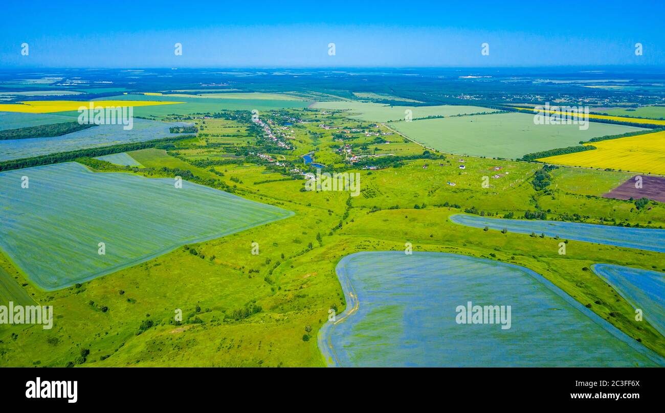 Aerial photos, colorful fields of flowering flax, rapeseed around a ...