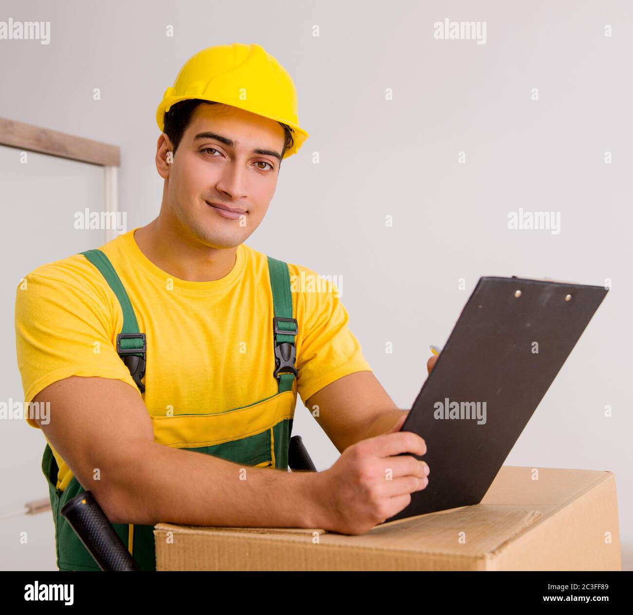 Man delivering boxes during house move Stock Photo - Alamy